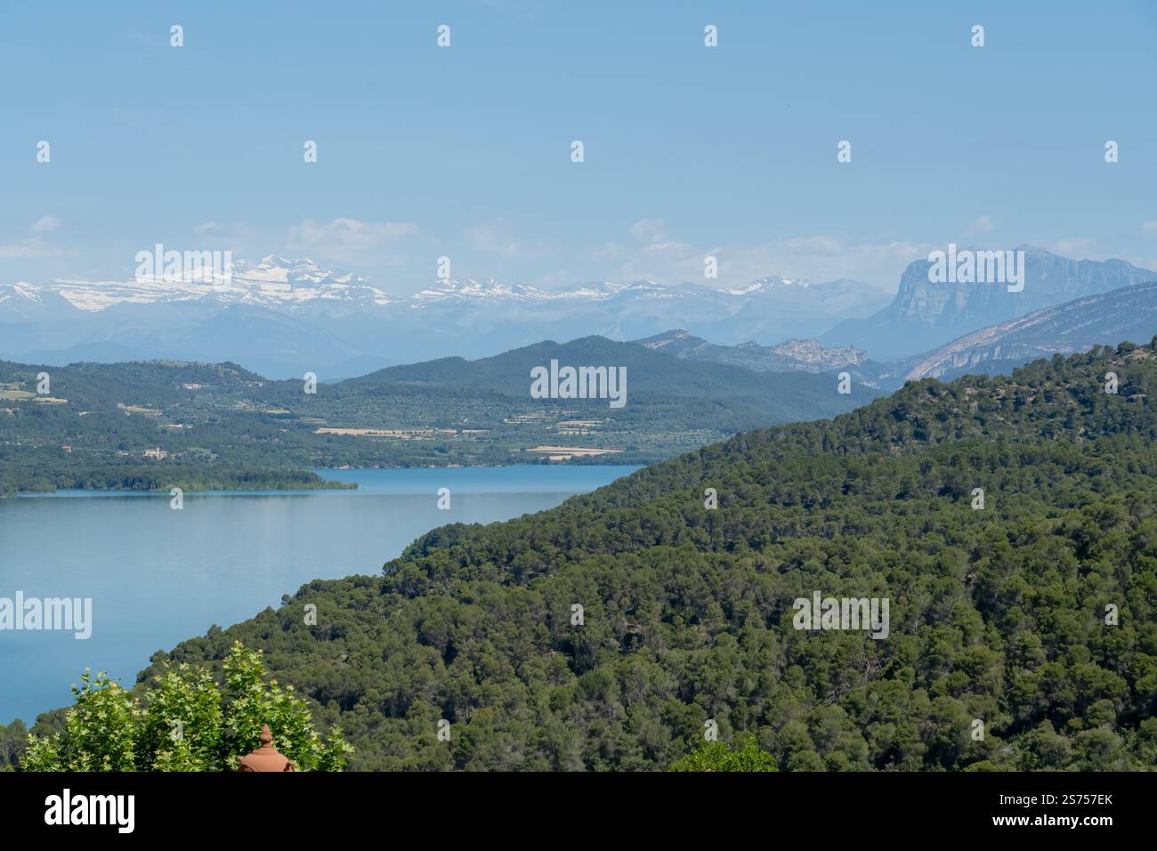 water, hills and distant Pyrenees mountains at Embalse de El Grado ...