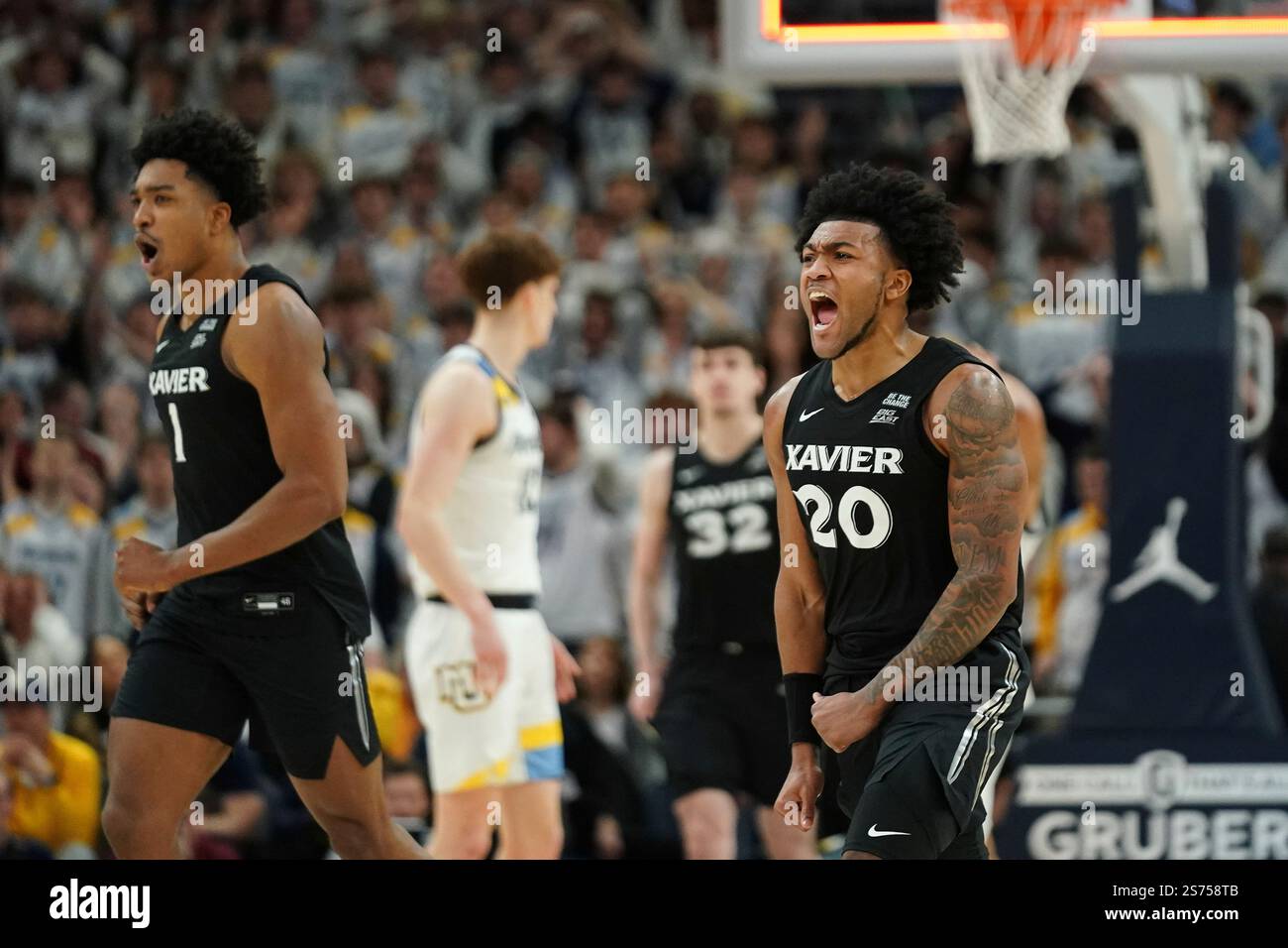 Xavier's Dayvion McKnight (20) and Marcus Foster (1) react after an ...