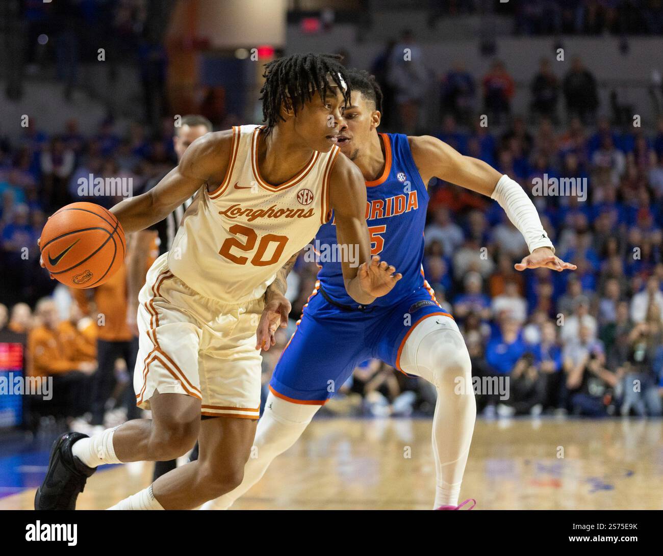 Texas guard Tre Johnson (20) drives on Florida guard Will Richard, right, during the first half ...