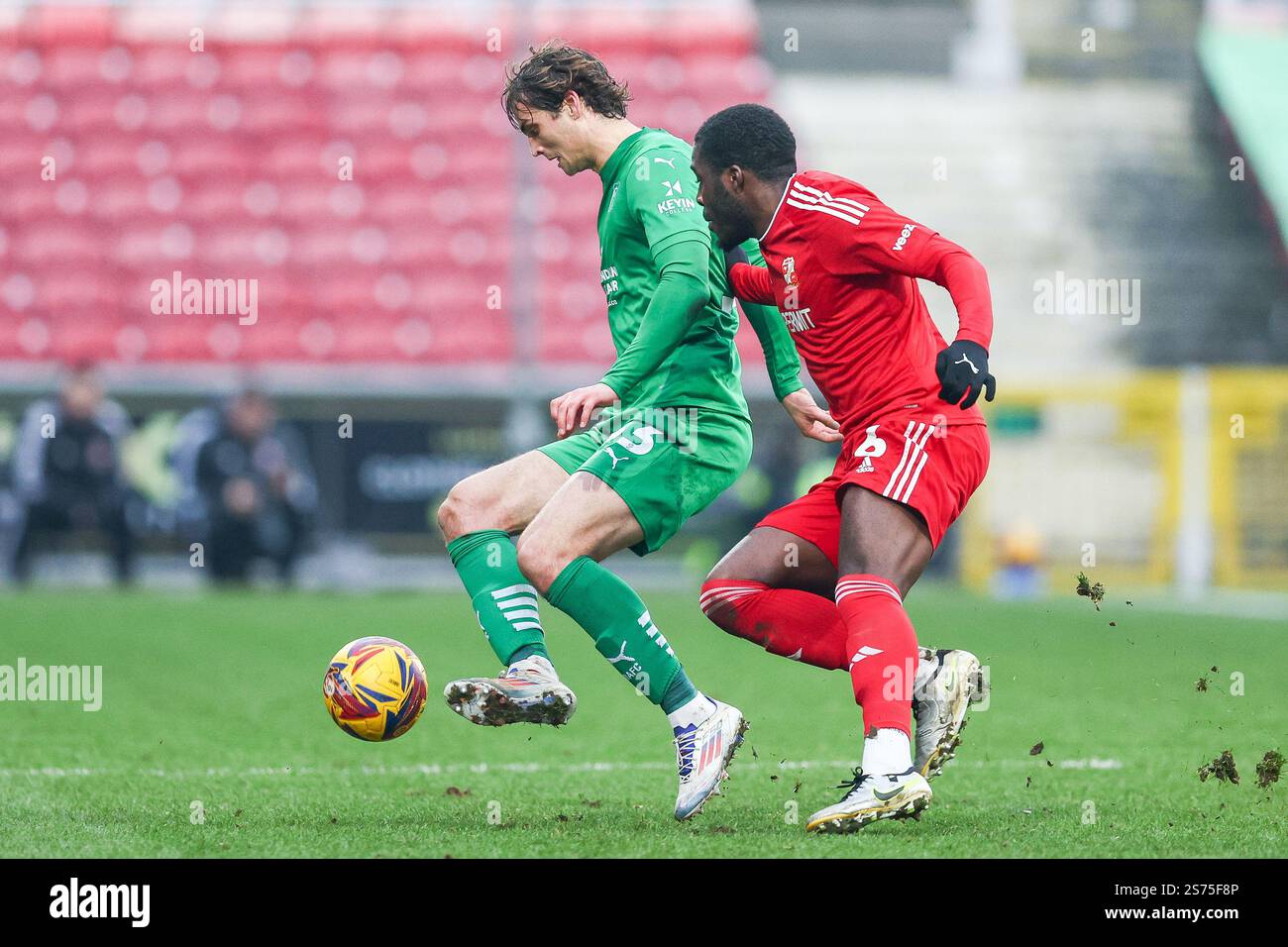 Swindon, UK. 18th Jan 2025. #33, Aaron Pressley of Barrow AFC & #6 ...