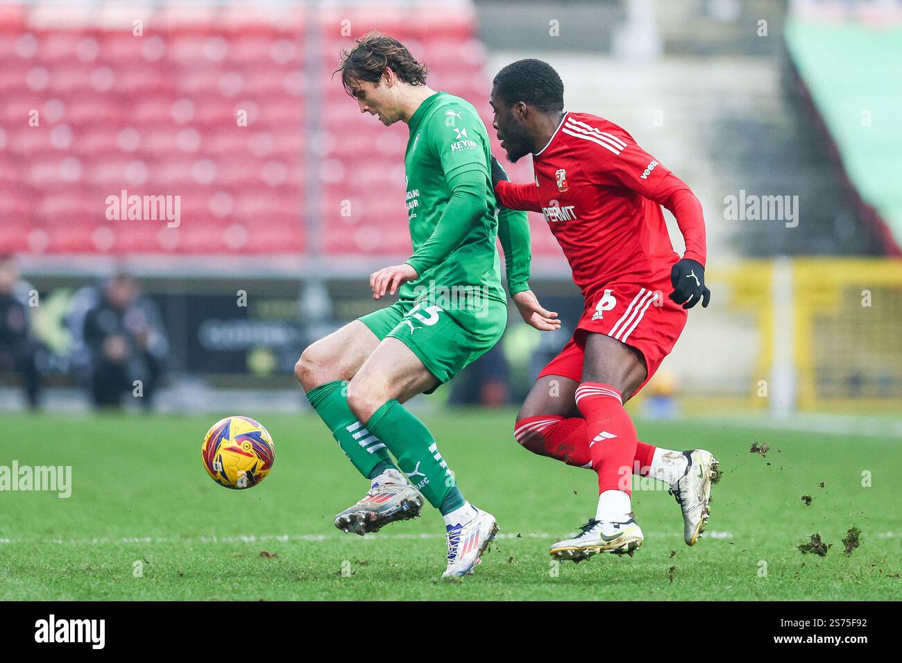 Swindon, UK. 18th Jan 2025. #33, Aaron Pressley of Barrow AFC & #6 ...