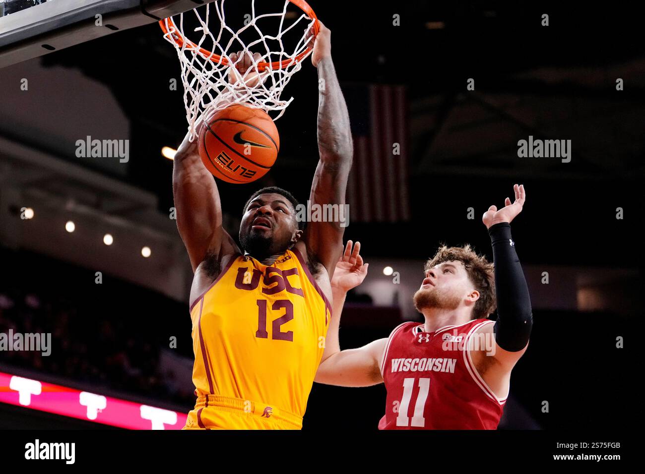 Southern California forward Rashaun Agee, left dunks as Wisconsin guard ...