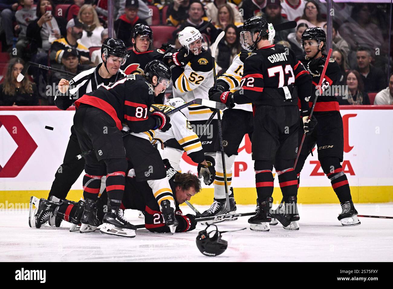 Boston Bruins' Brad Marchand (63) fights with Ottawa Senators' Nick ...