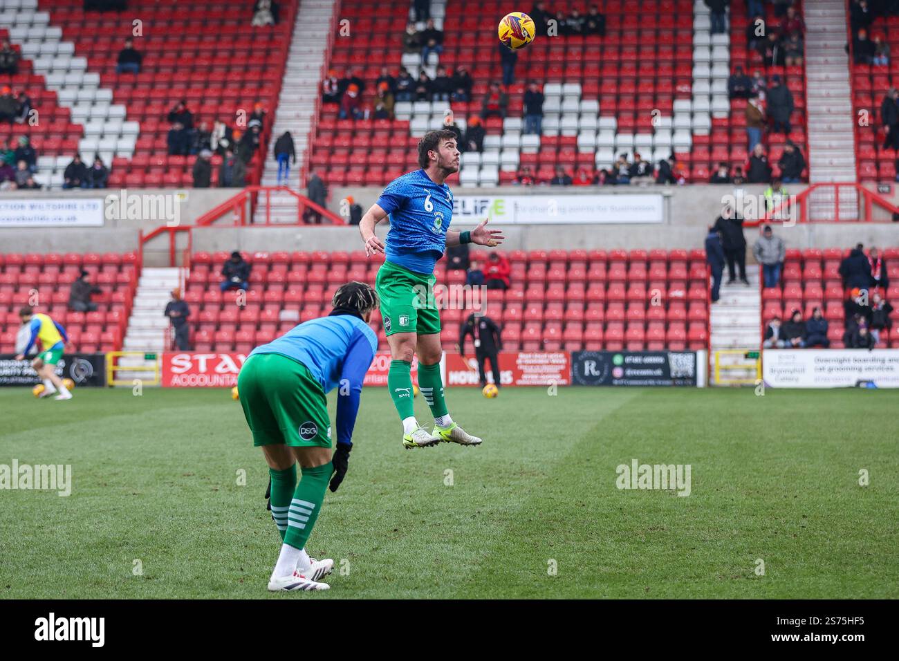 Swindon, UK. 18th Jan 2025. #6, Niall Canavan of Barrow AFC heads the ...