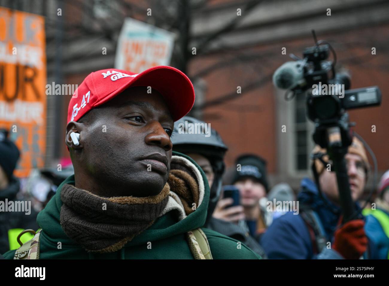 Washington, USA. 18th Jan, 2025. A man wearing a MAGA hat is removed ...
