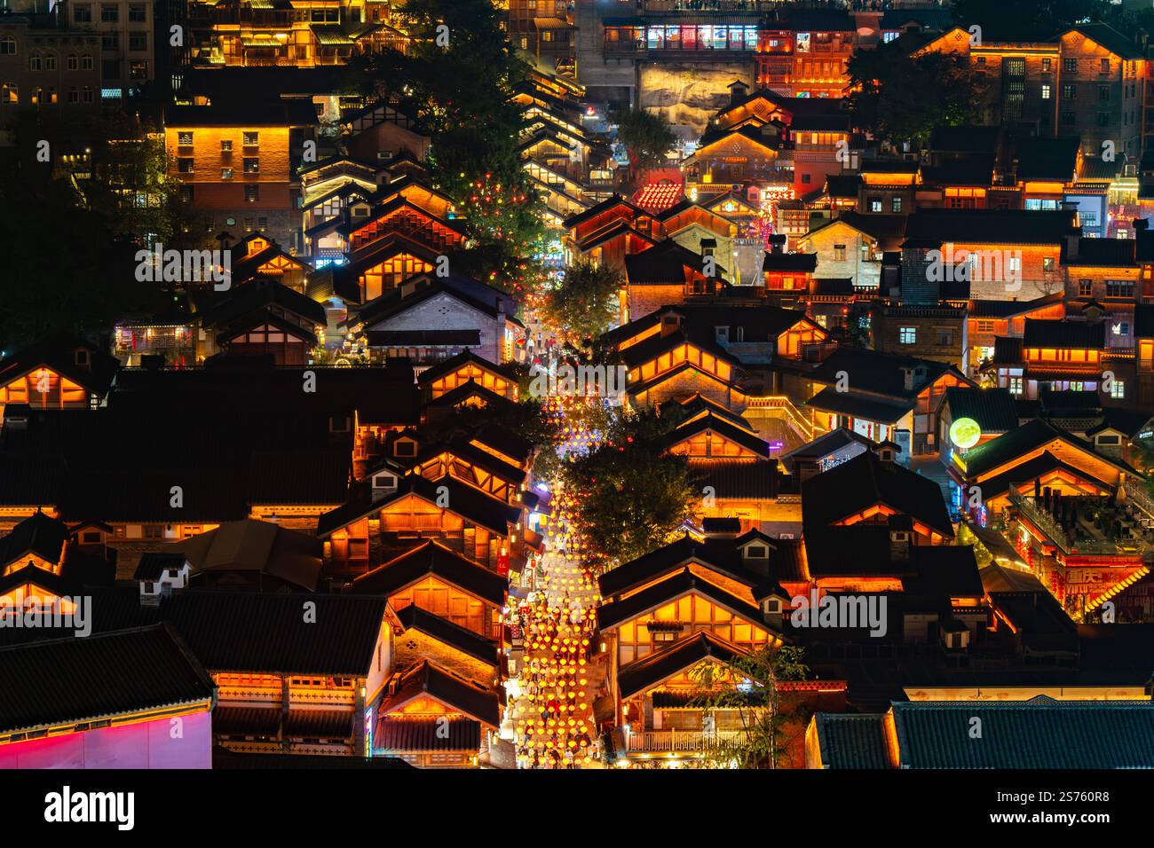 CHONGQING, CHINA - JANUARY 18, 2025 - Tourists play in the brightly lit ...
