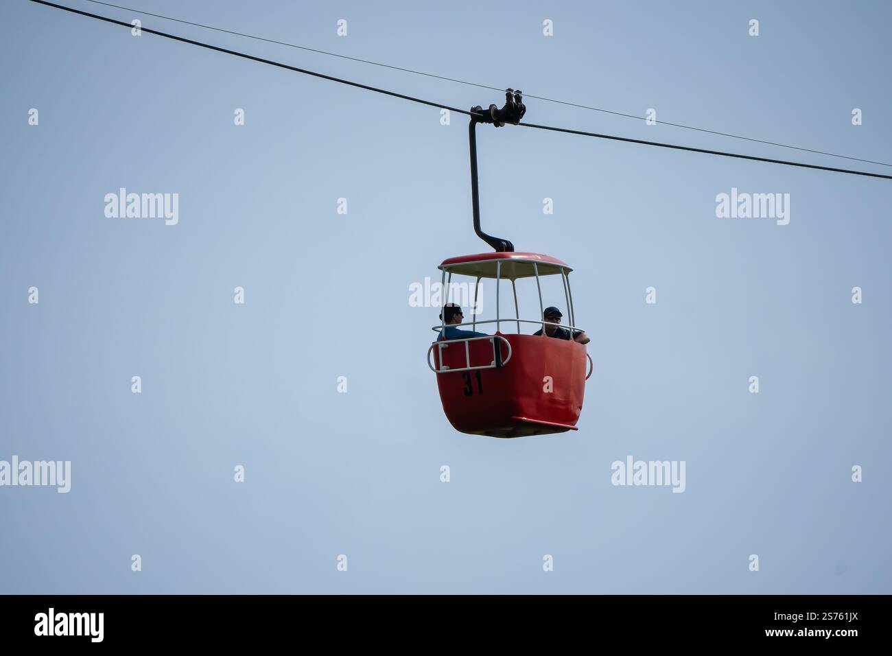 a passenger cable car gondola cabin travelling between pylons, opened ...