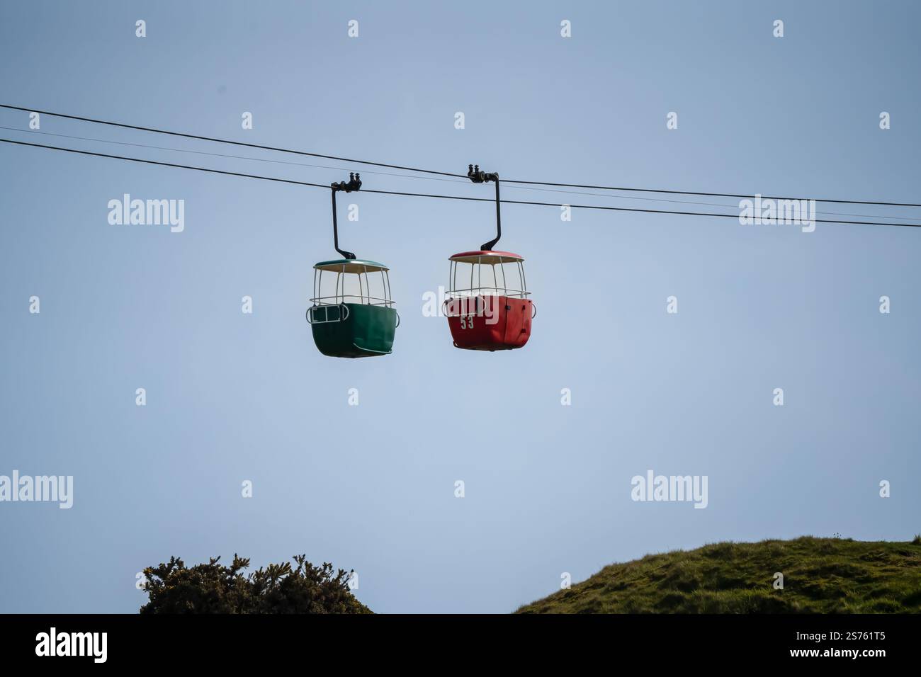 a passenger cable car gondola cabin travelling between pylons, opened ...