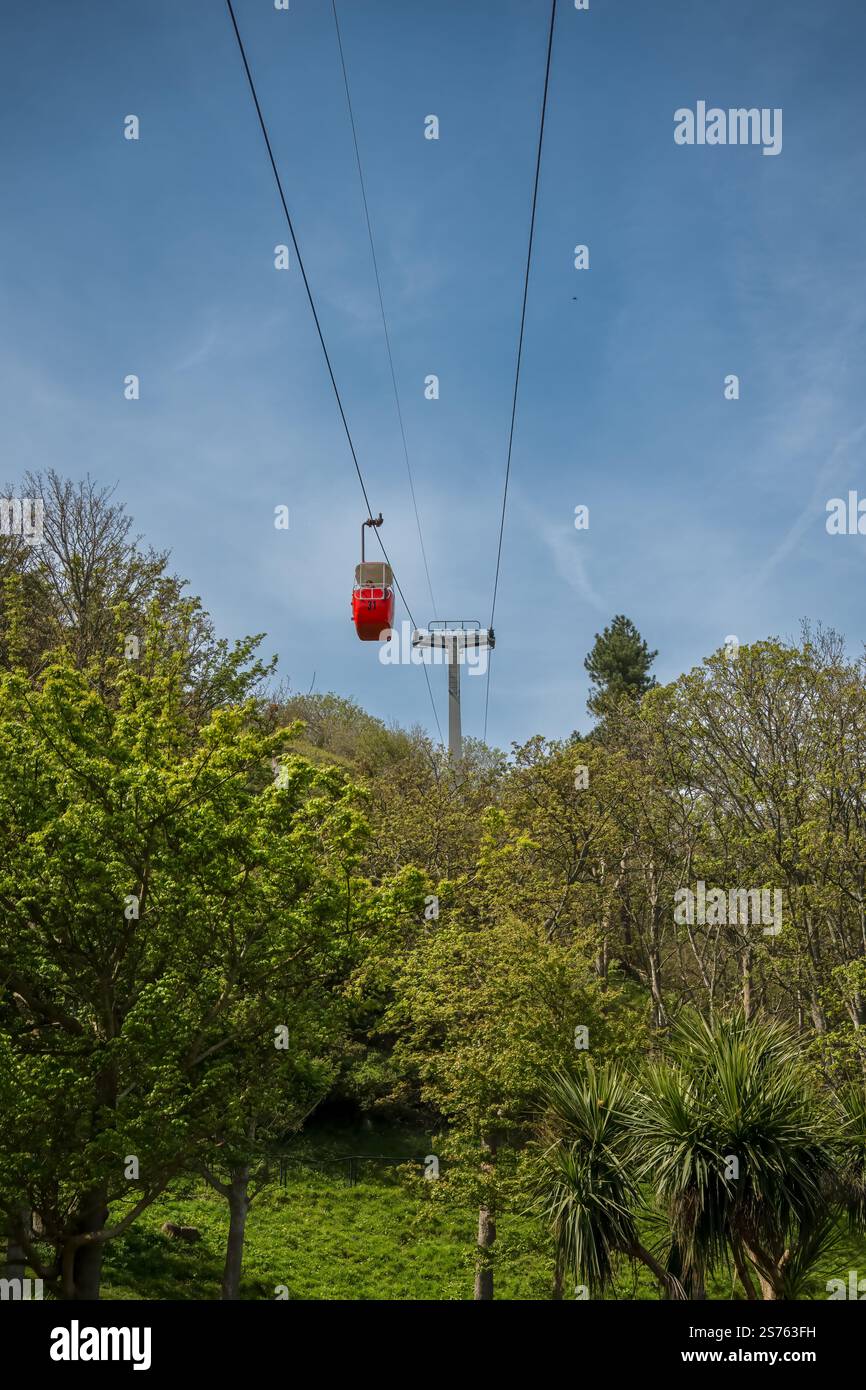 a passenger cable car gondola cabin travelling between pylons, opened ...