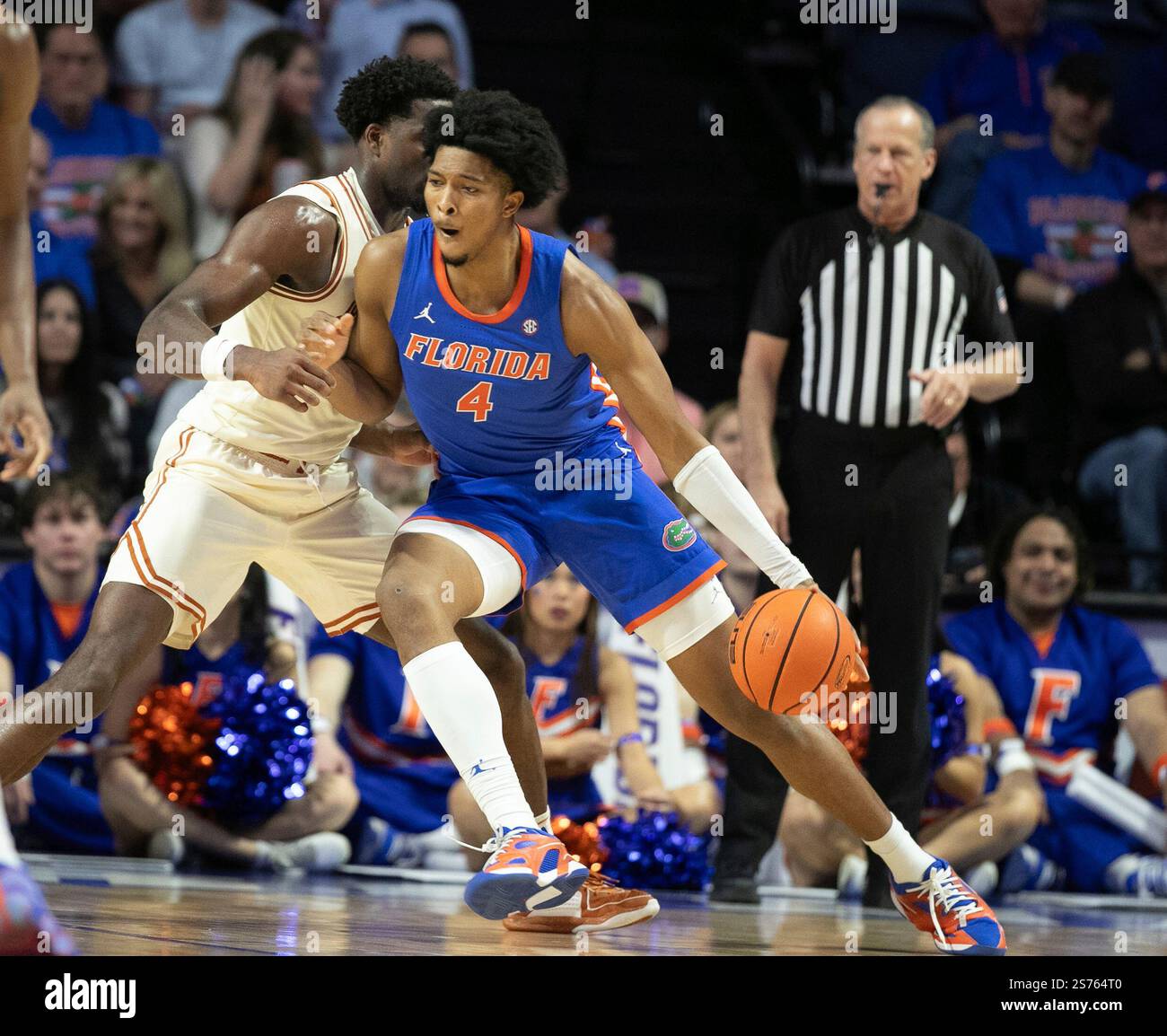 Florida forward Sam Alexis (4) drives against Texas guard Chendall ...