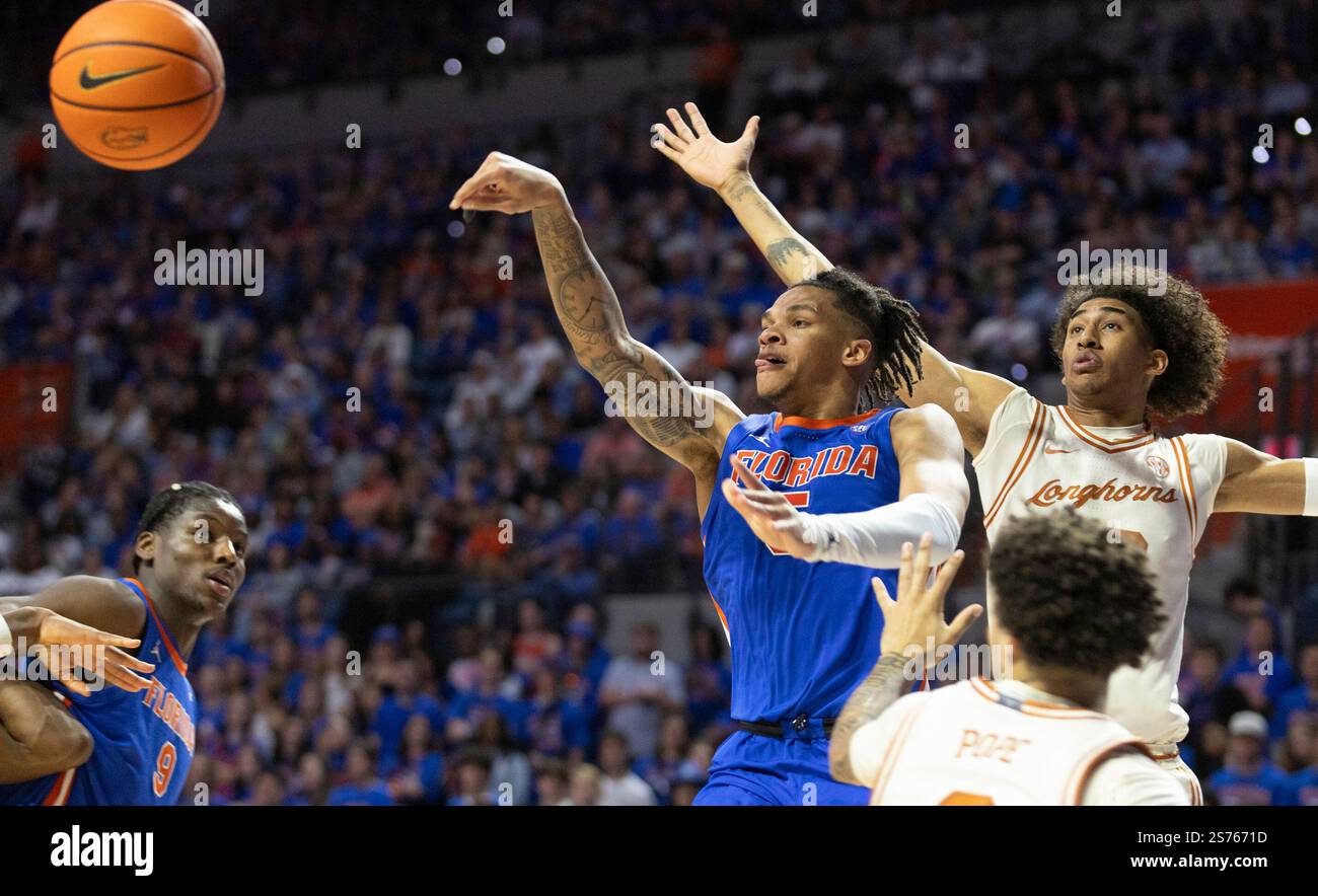 Florida guard Will Richard, center, passes under pressure from Texas ...