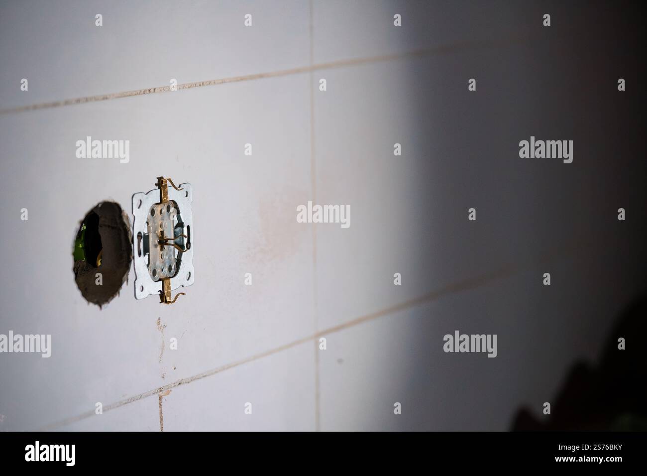Electrical Outlet Installation with Exposed Wiring in a Tiled Wall ...