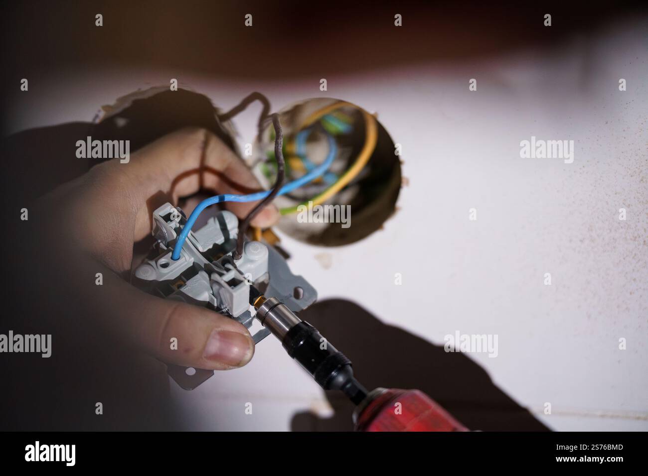 Electrical Repair Work: Installing a New Switch Within a Wall Cavity Stock Photo - Alamy