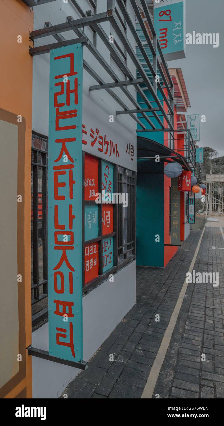 A street view of a building with colorful Korean and Japanese signs ...