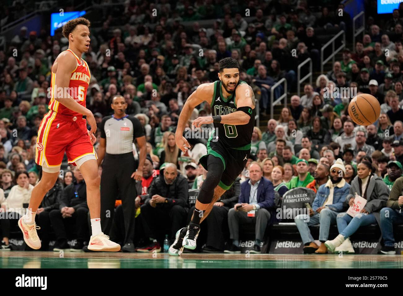 Boston Celtics' Jayson Tatum (0) runs by Atlanta Hawks' Dyson Daniels (5) while chasing the ball ...