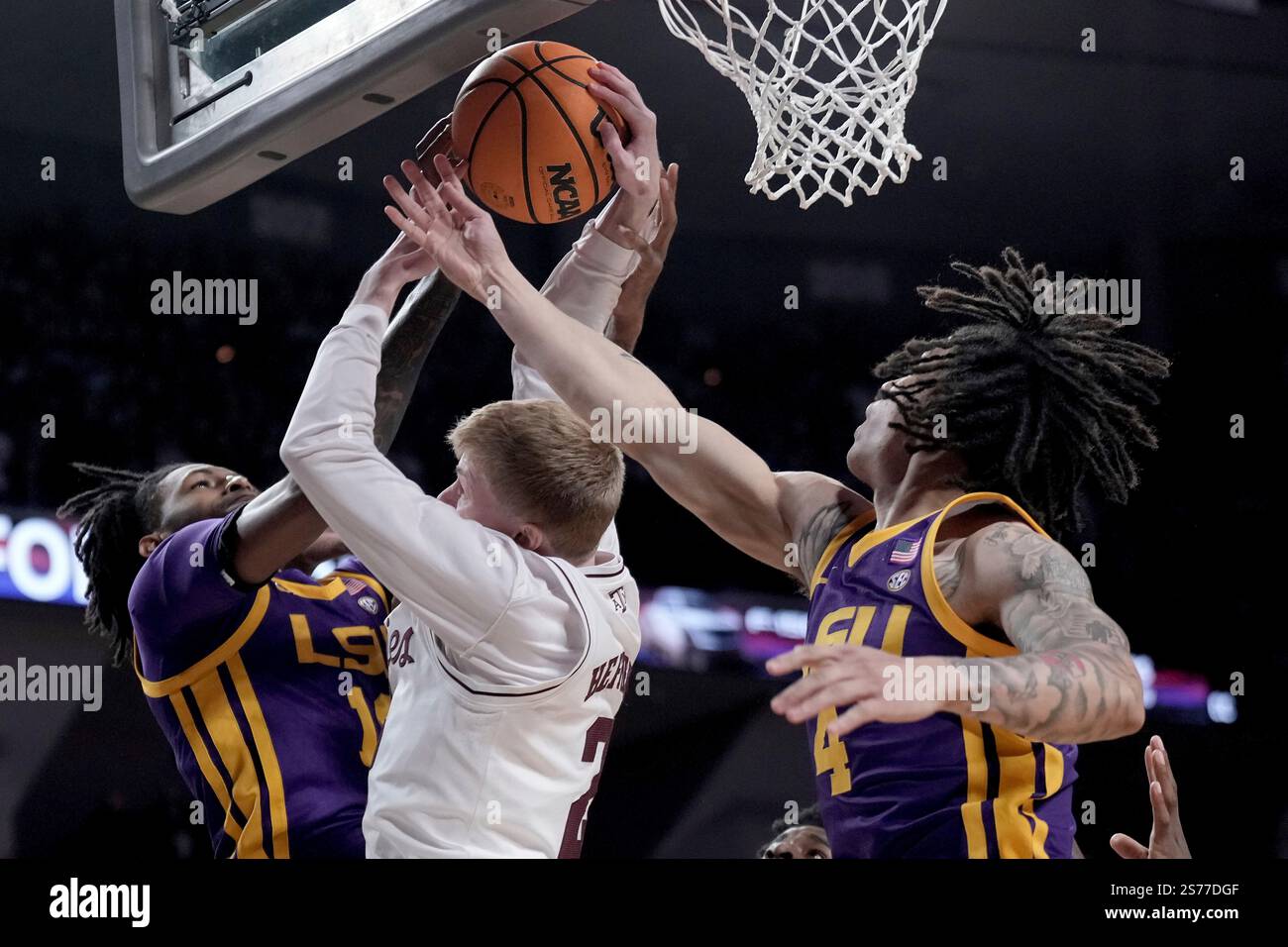 Texas A&M guard Hayden Hefner, center, fights for a rebound against LSU ...