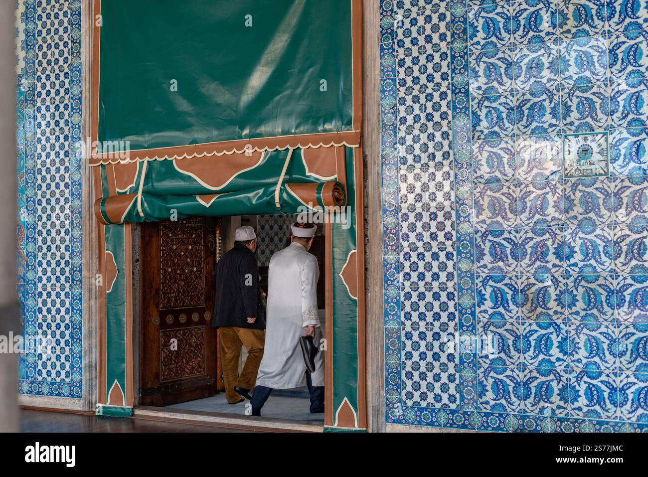 A Turkish Imam entering the prayer hall of the newly restored Rustem ...