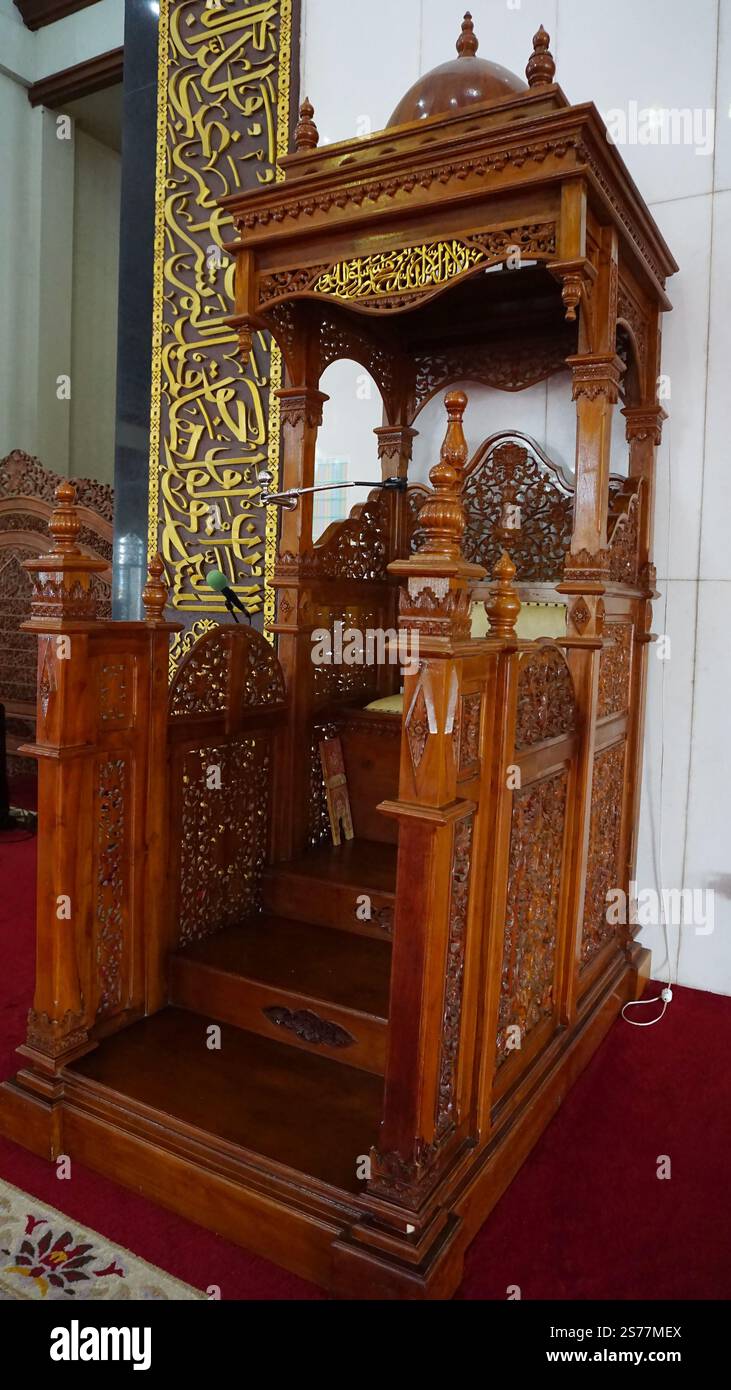A beautifully crafted wooden minbar, intricately designed with carvings ...
