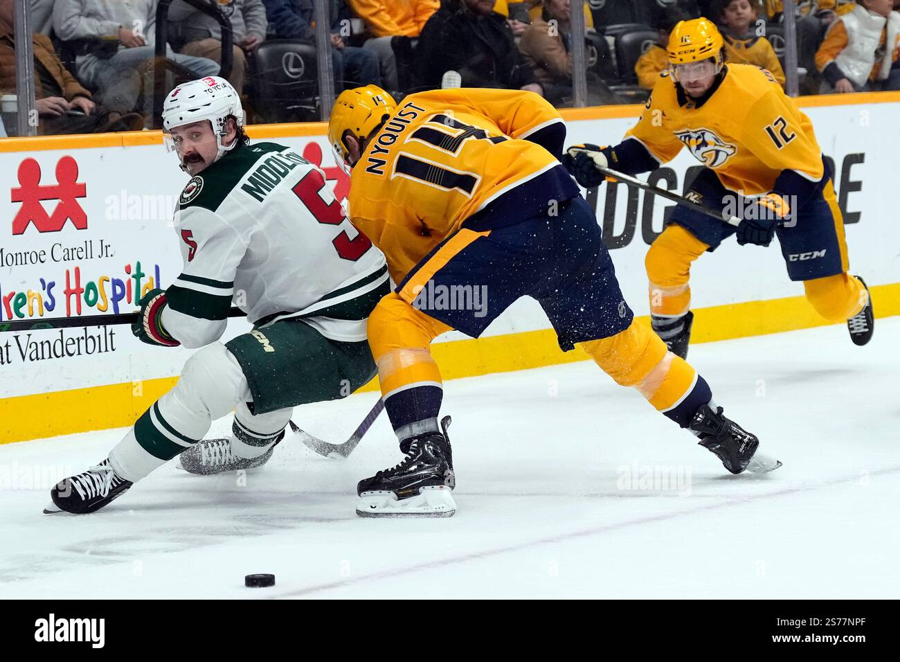 Minnesota Wild defenseman Jake Middleton (5) battles for the puck with ...