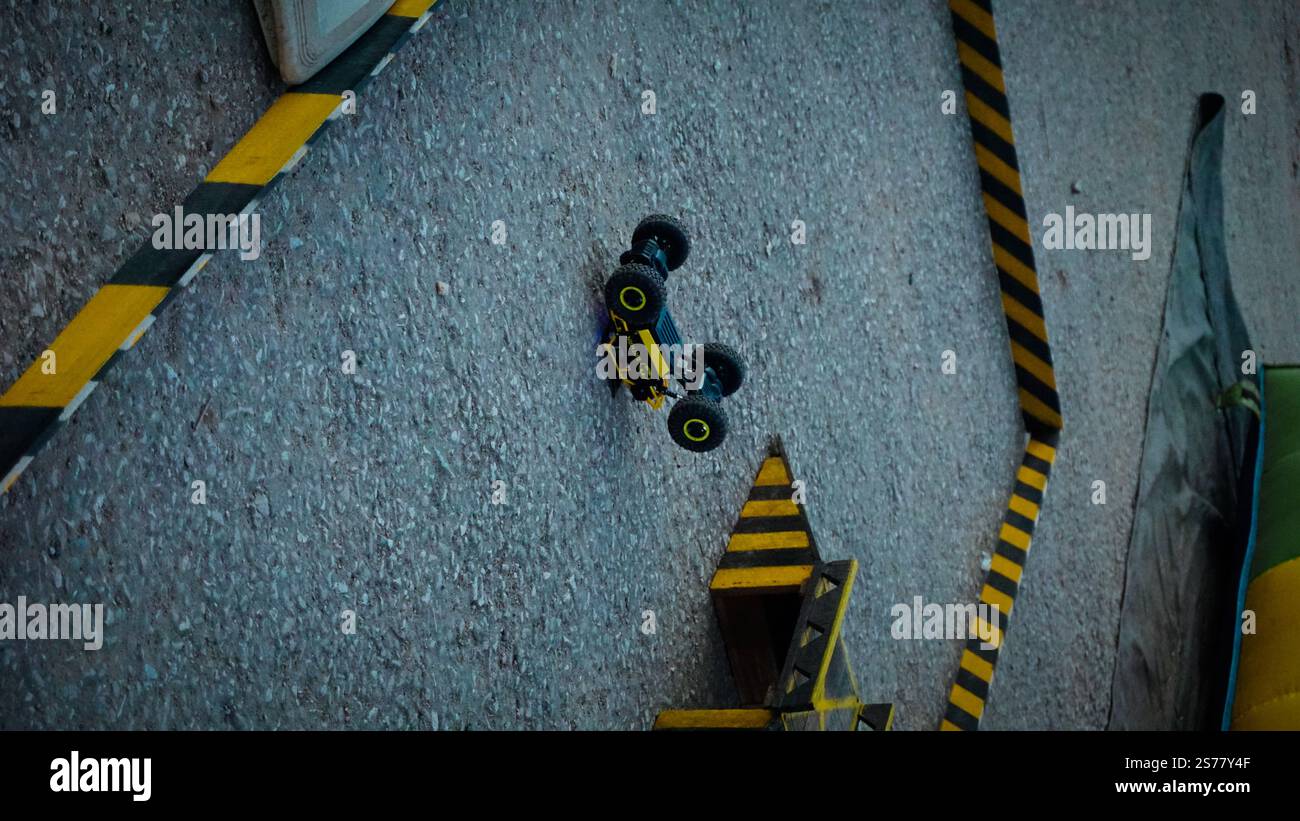 A remote-controlled car performing tricks on a vertical surface ...