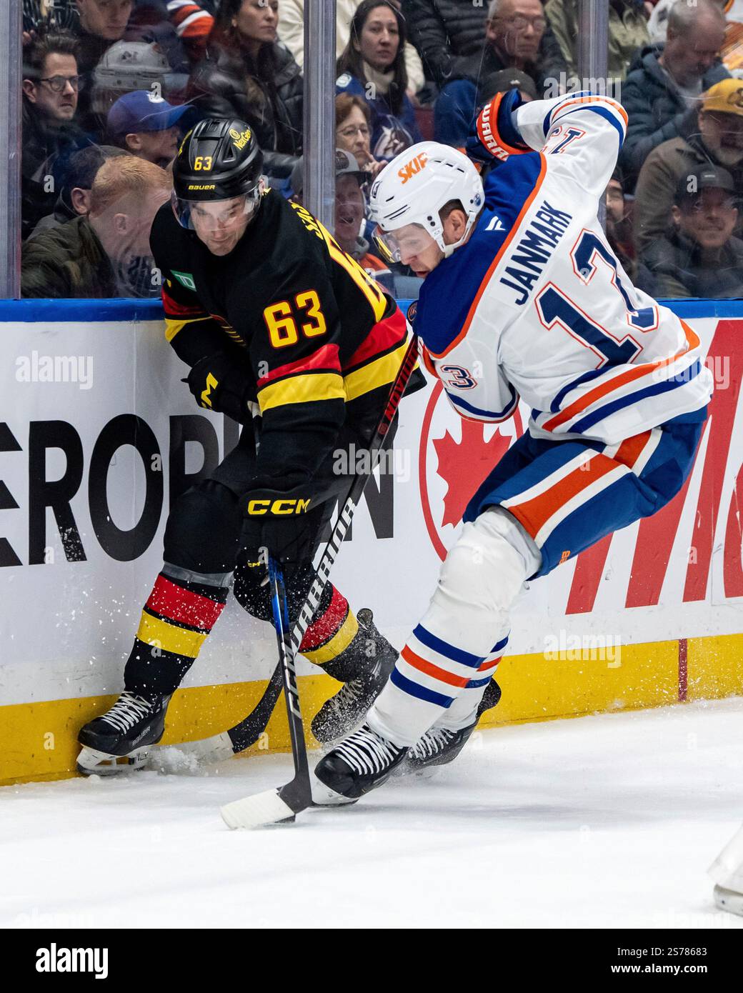Vancouver Canucks' Max Sasson (63) and Edmonton Oilers' Mattias Janmark ...