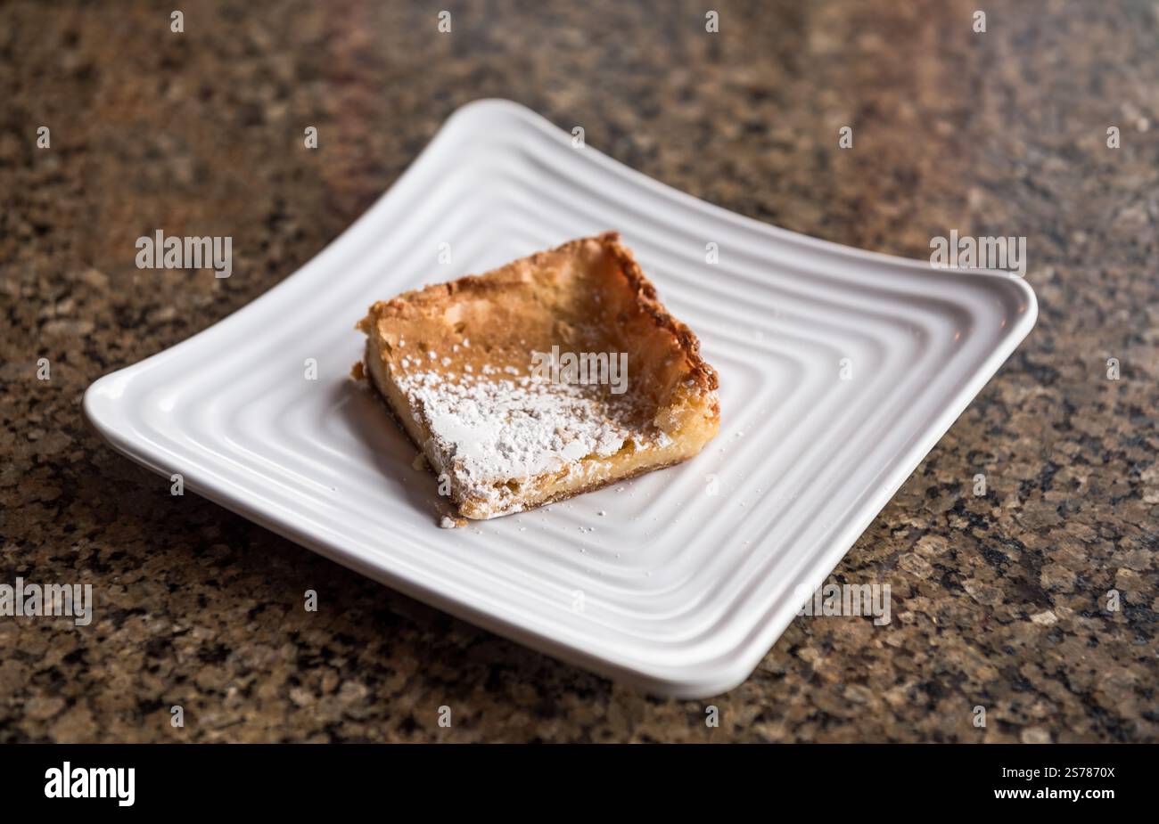Gooey butter cake is a dense cake made with cake flour, butter, and ...