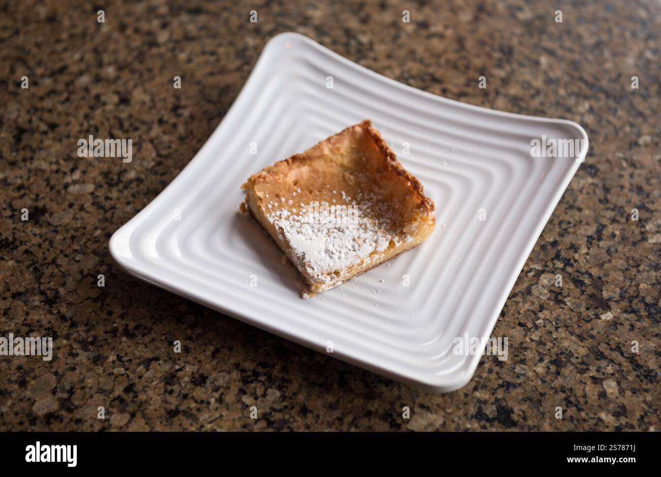 Gooey butter cake is a dense cake made with cake flour, butter, and ...