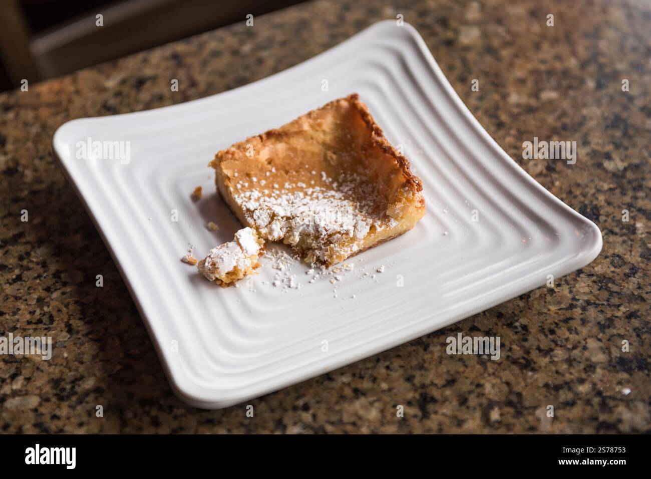 Gooey butter cake is a dense cake made with cake flour, butter, and ...