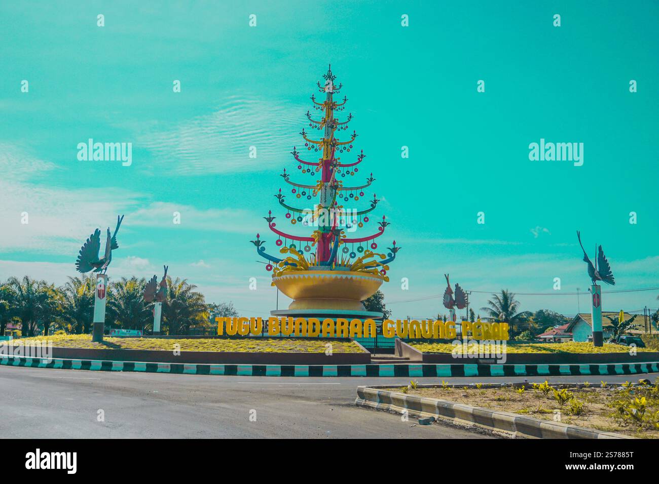 A colorful roundabout monument featuring a large decorative tree with ...