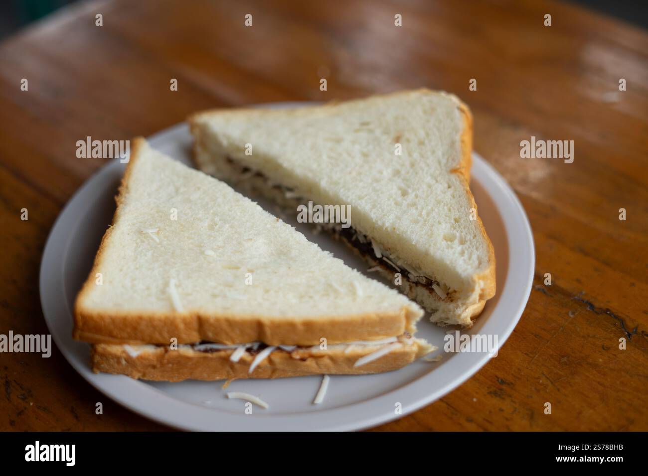 A cut chocolate crunch sandwich on a plate, ready to be enjoyed Stock ...