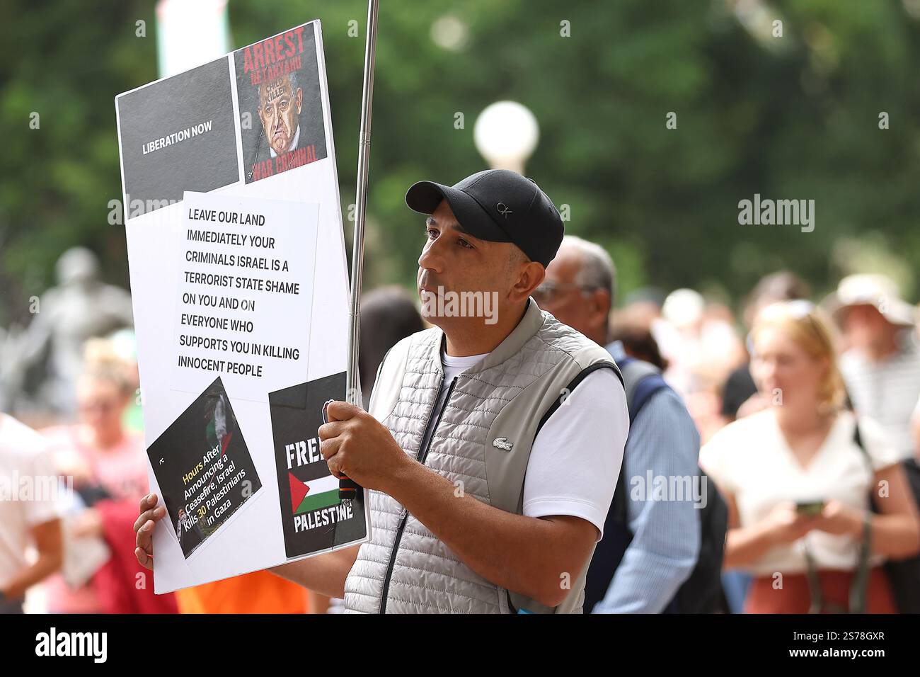 Sydney, Australia. 19th Jan, 2025. A rallygoer holds a placard during a ...