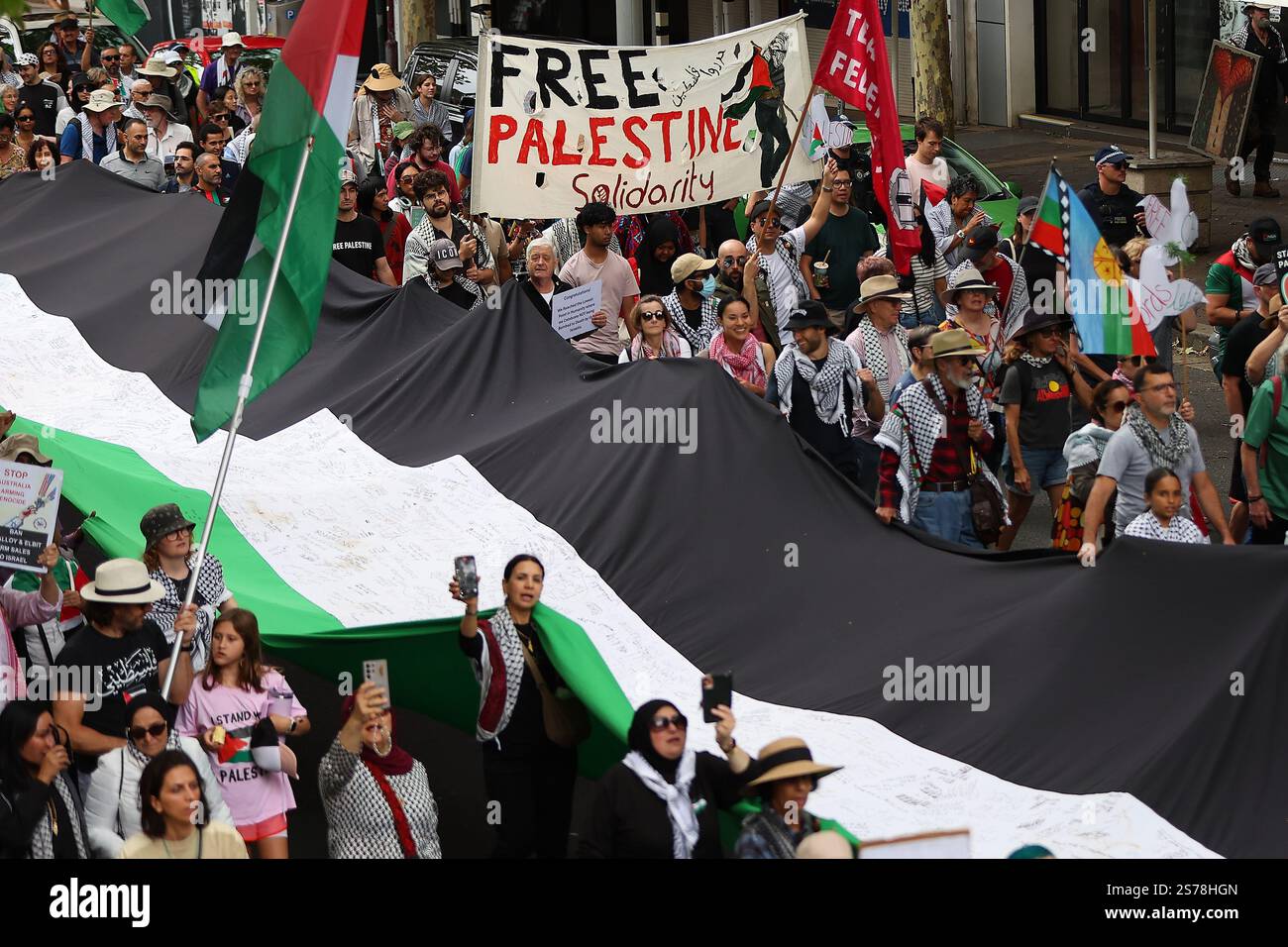 Sydney, Australia. 19th Jan, 2025. Rallygoers chant and walk through ...