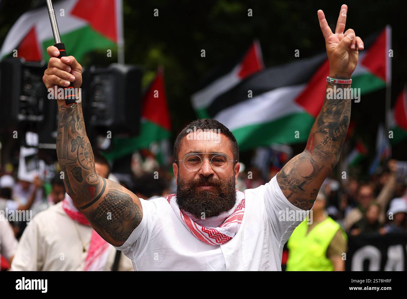Sydney, Australia. 19th Jan, 2025. A rallygoer chants and gestures ...