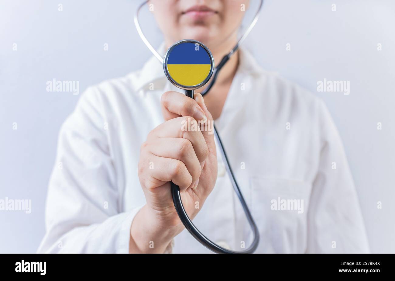 Female doctor holding stethoscope with Ukraine flag. National Health ...