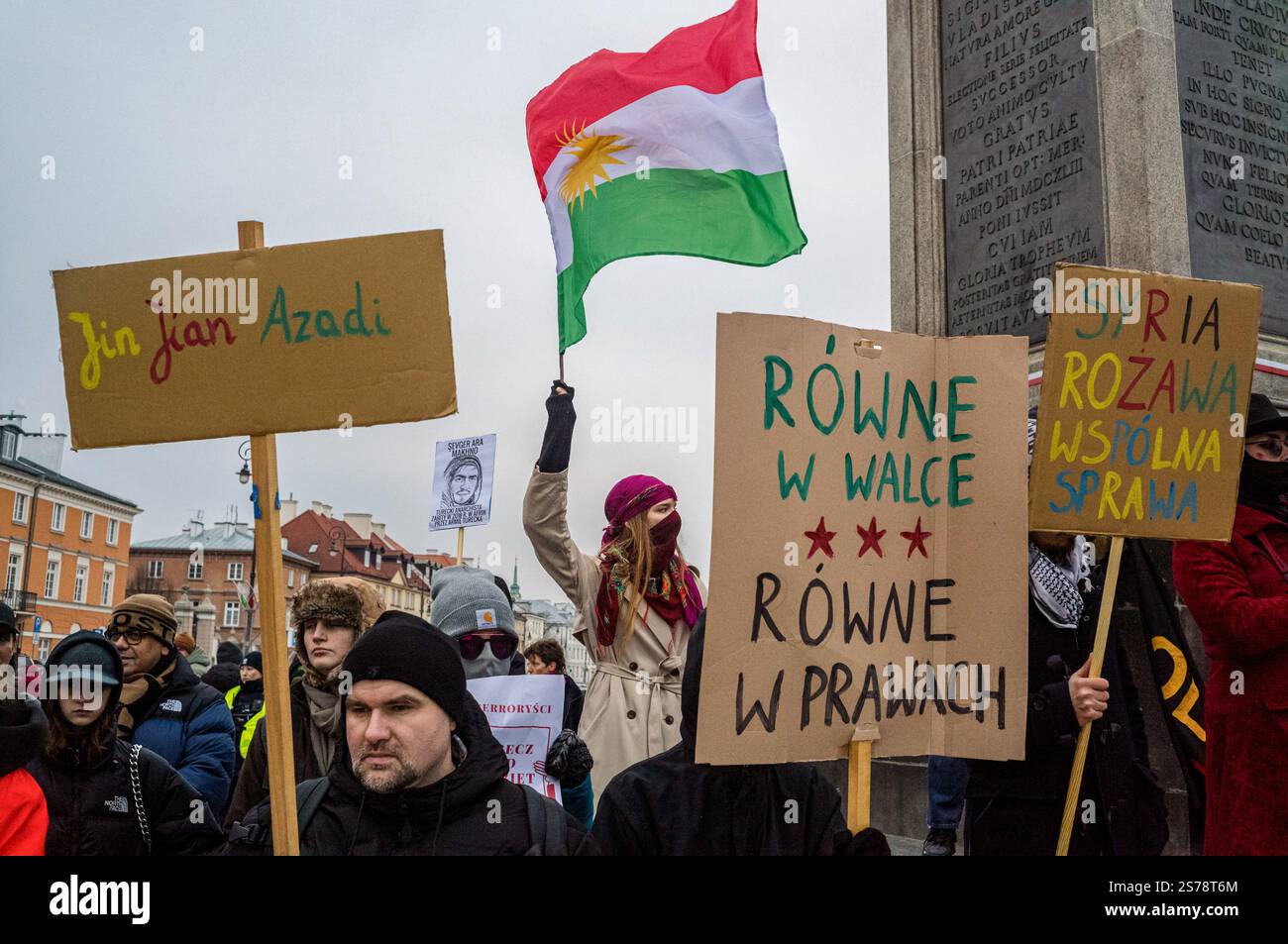 Protestors hold banners, placards, and flags. In solidarity with the ...