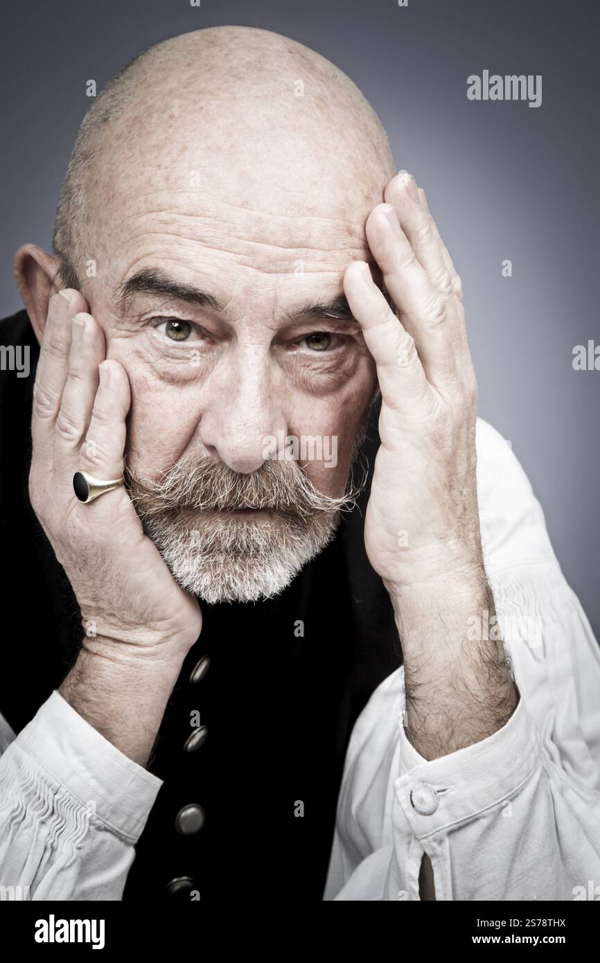 An old man with a grey beard is hopeless Stock Photo - Alamy