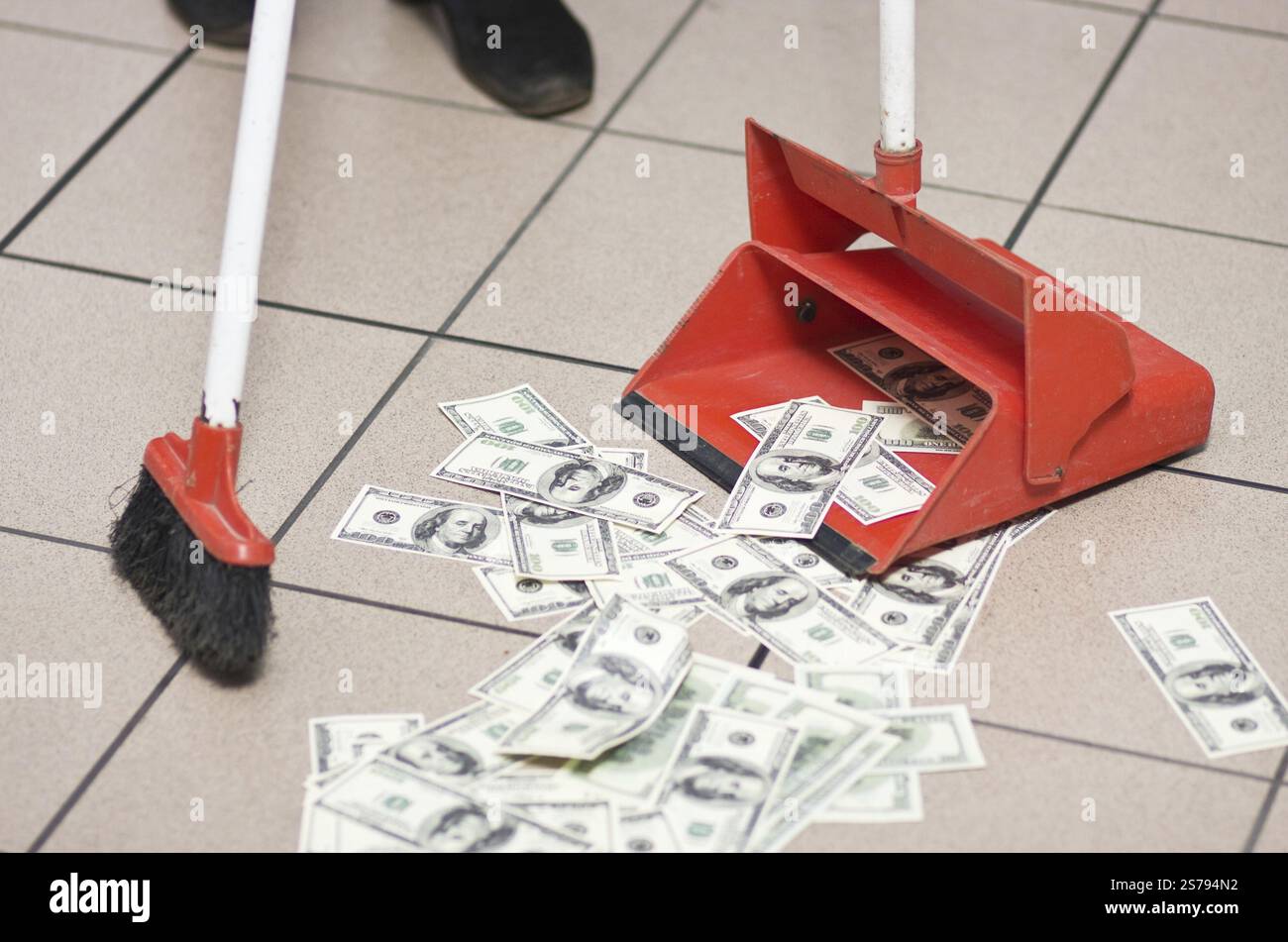 One hundred dollar notes scattered on the floor and cleaned with a ...