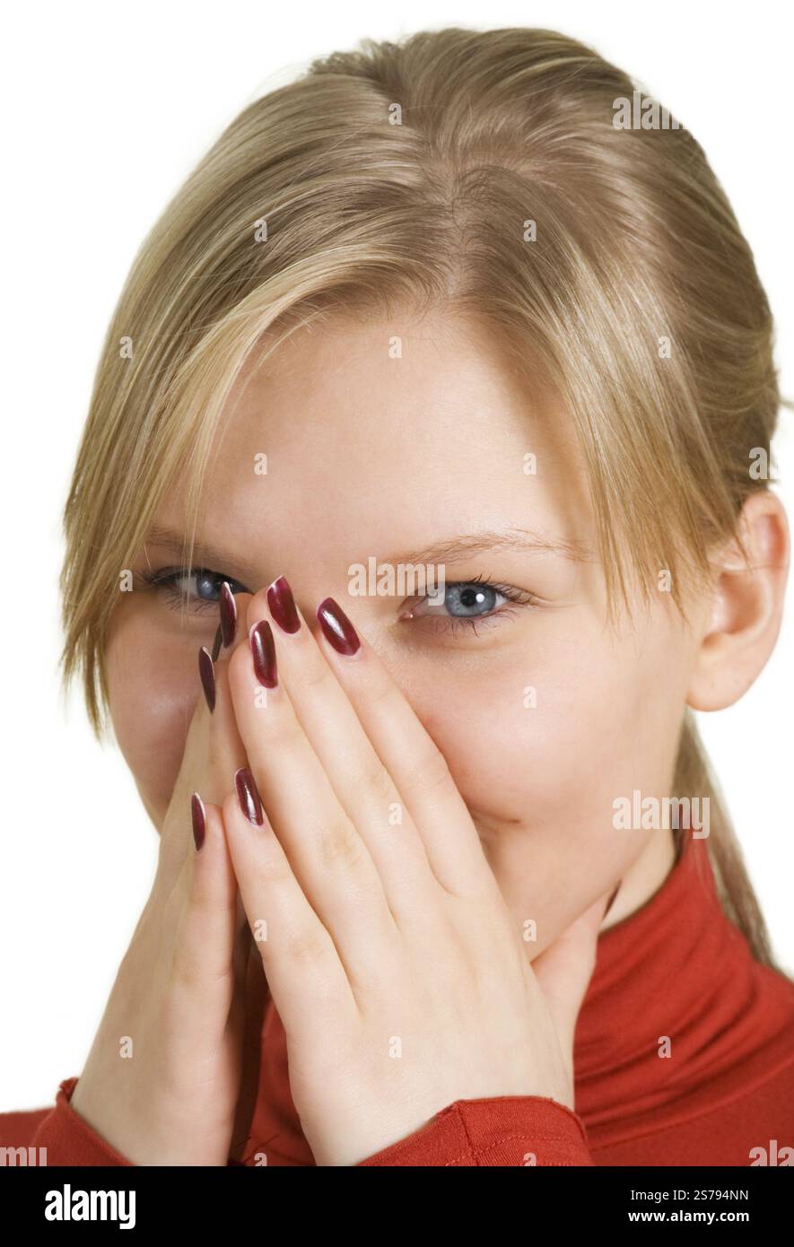 Pretty smiling blonde girl hiding face behind her hands Stock Photo - Alamy