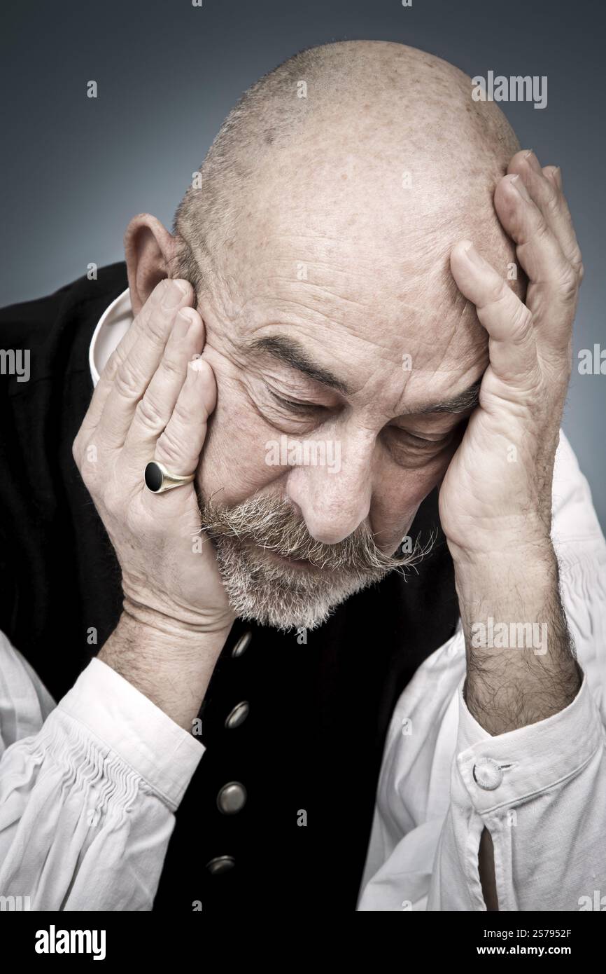 An old man with a grey beard is hopeless Stock Photo - Alamy