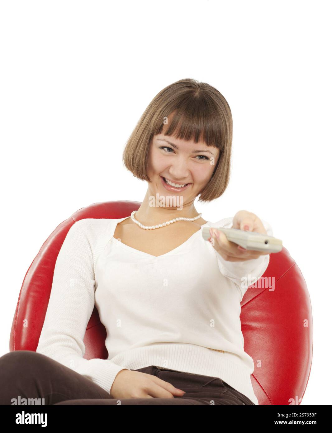 Happy young woman pointing at the TV with the remote control, Russian ...