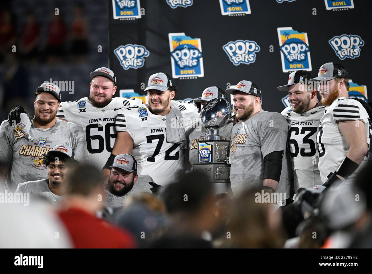 Iowa State offensive lineman pose with the championship trophy after ...