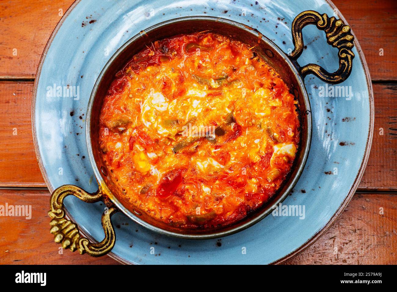 Traditional turkish menemen in copper pan with tomatoes and peppers ...
