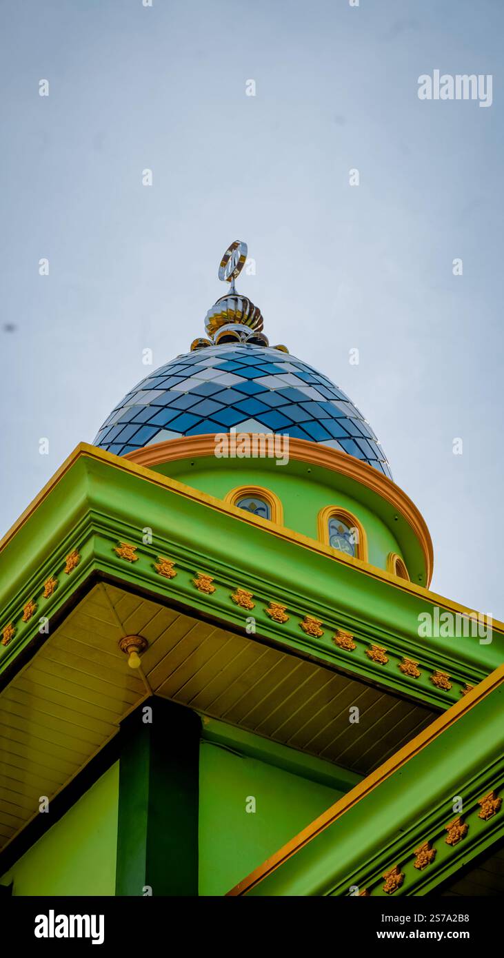 A close-up view of a colorful mosque dome featuring intricate designs ...