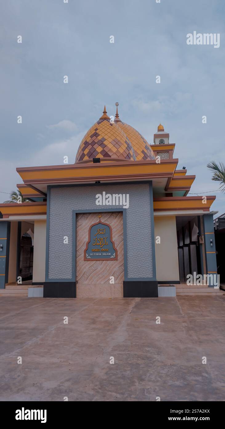 A beautifully designed mosque with a golden dome and intricate patterns ...