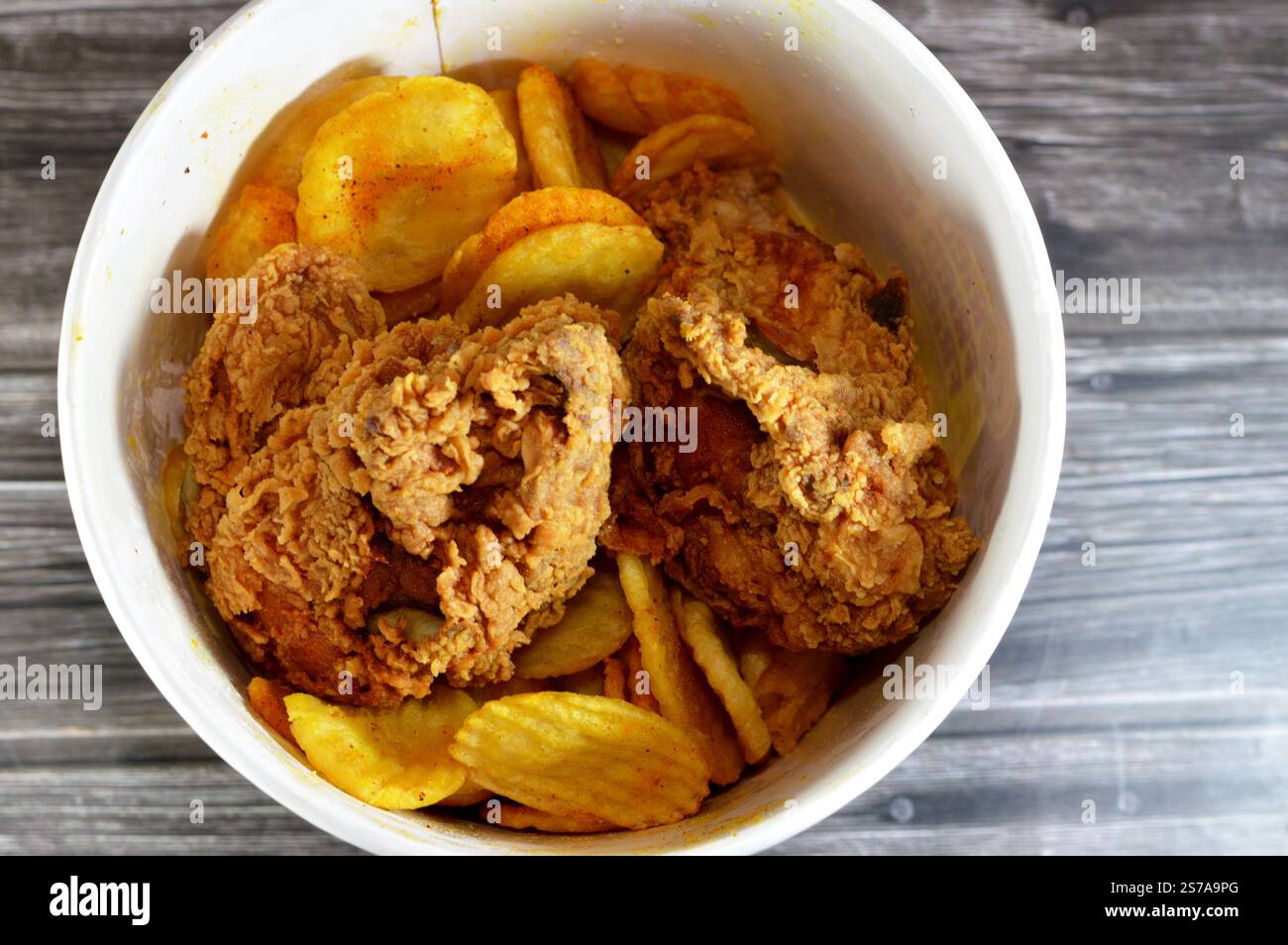 Broasted chicken meal with fried potato chips, a broast chicken pieces ...