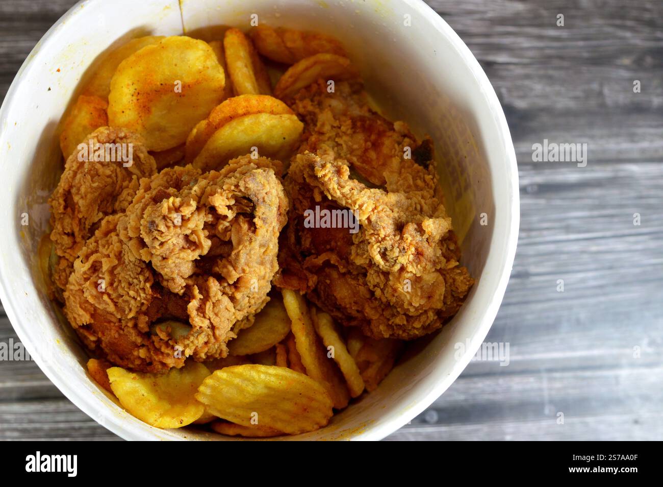 Broasted chicken meal with fried potato chips, a broast chicken pieces ...