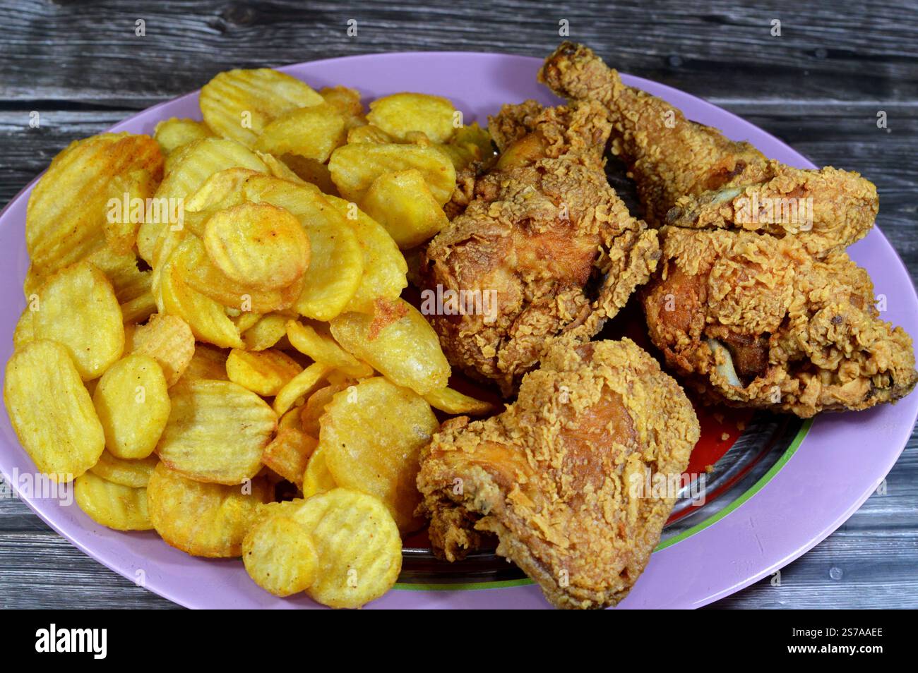 Broasted chicken meal with fried potato chips, a broast chicken pieces ...