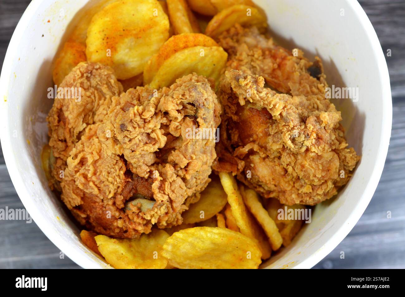 Broasted chicken meal with fried potato chips, a broast chicken pieces ...