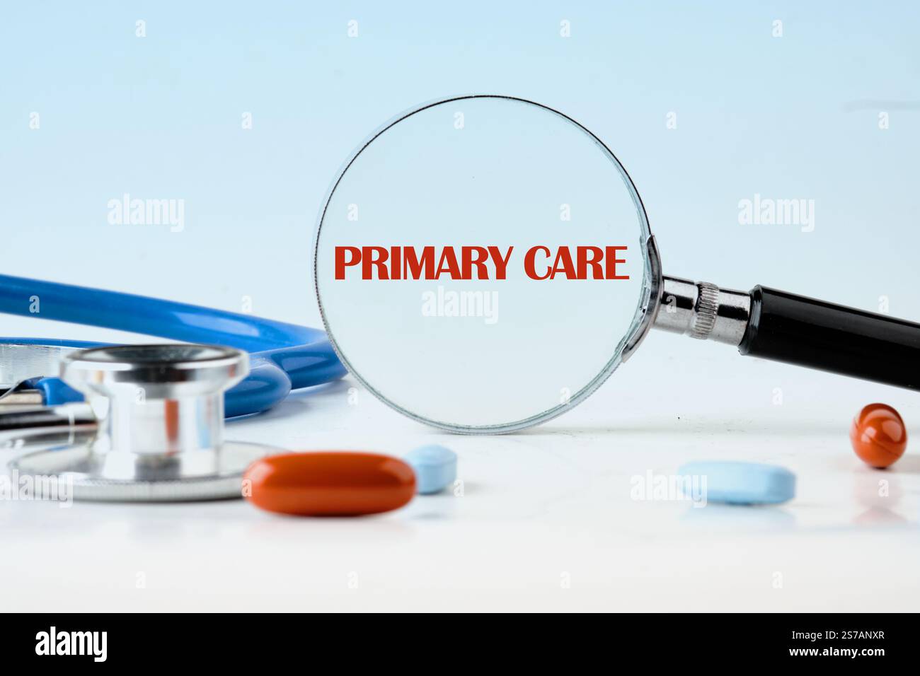 Magnifying glass highlighting primary care alongside stethoscope and ...