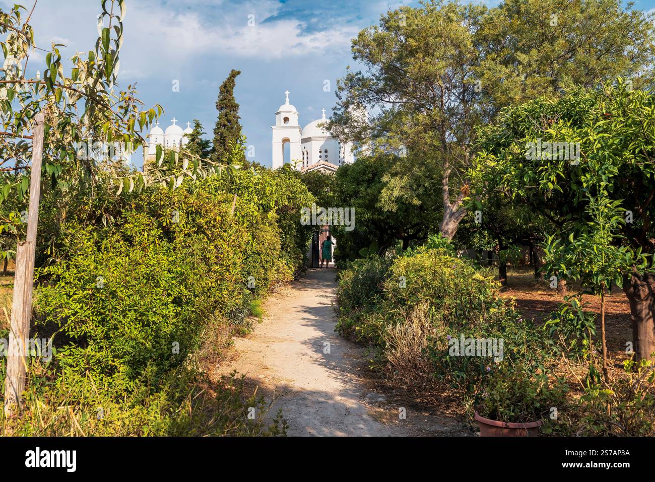 A serene dirt pathway leading to Iera Moni Timiou Prodromou, surrounded ...